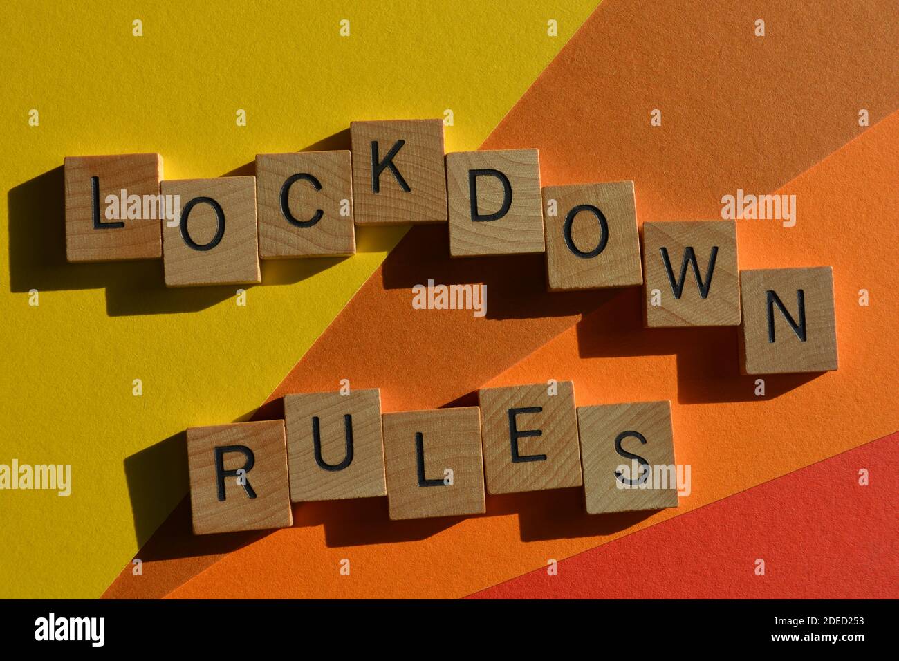 Lockdown Rules, phrase in wooden alphabet letters isolated on colourful ...