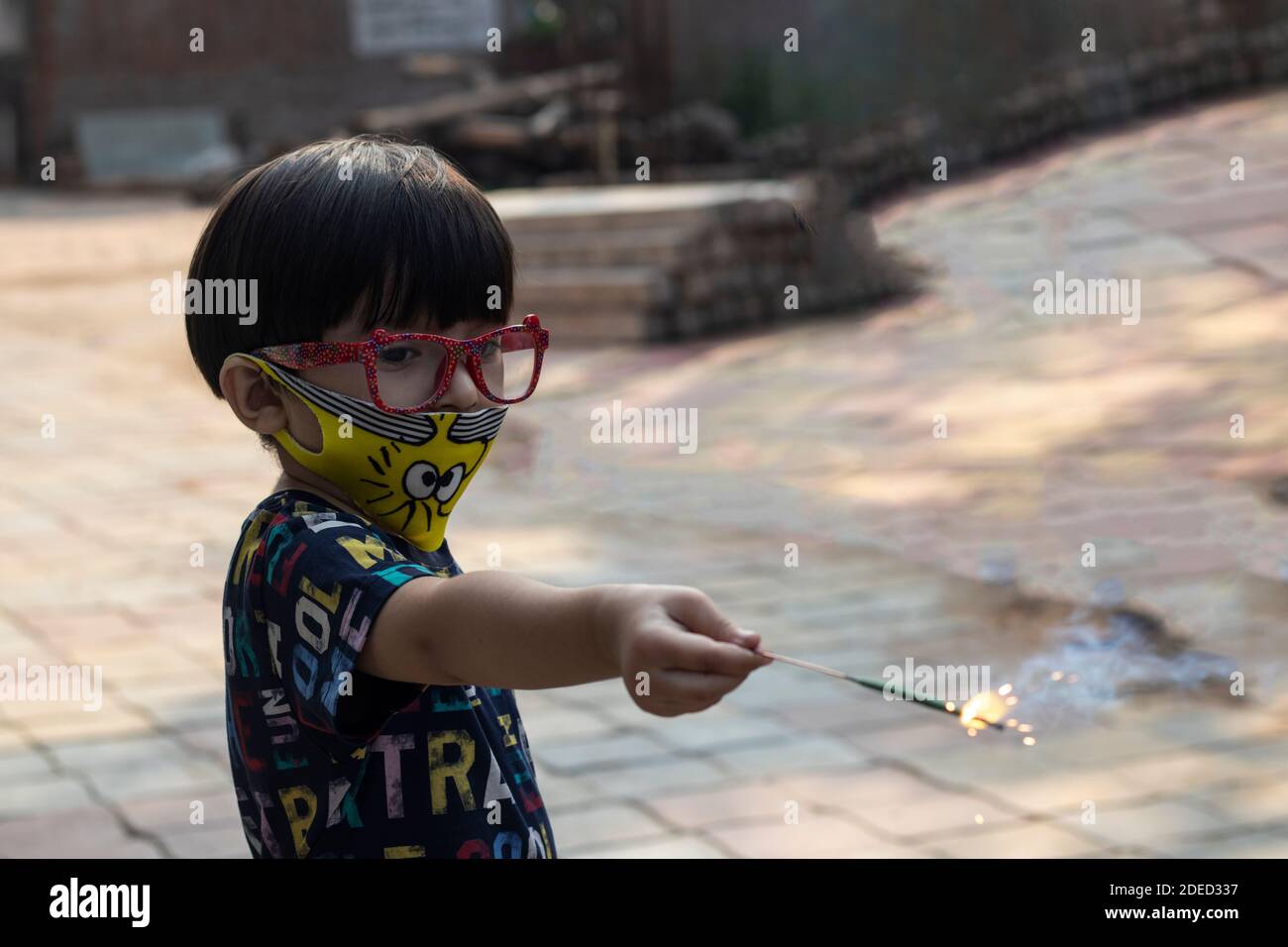 Indian cute boy playing with crackers, wearing mask Stock Photo - Alamy