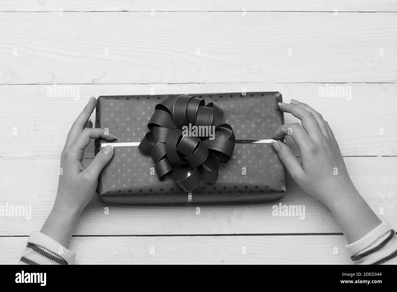 Christmas gift wrapped in red Black and White Stock Photos & Images - Alamy