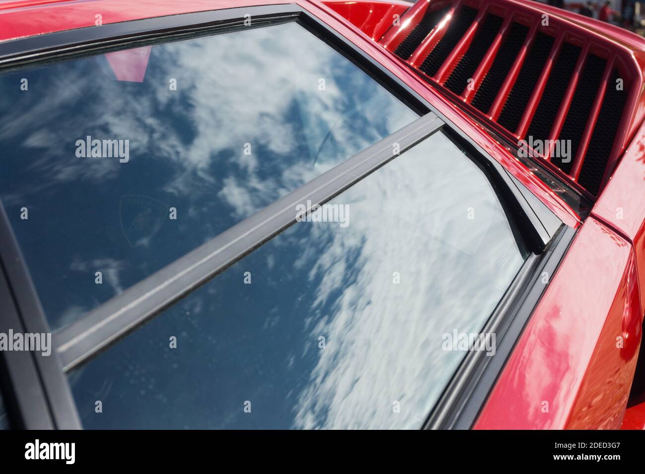 Close up detail of the right side door and window of a red Lamborghini ...