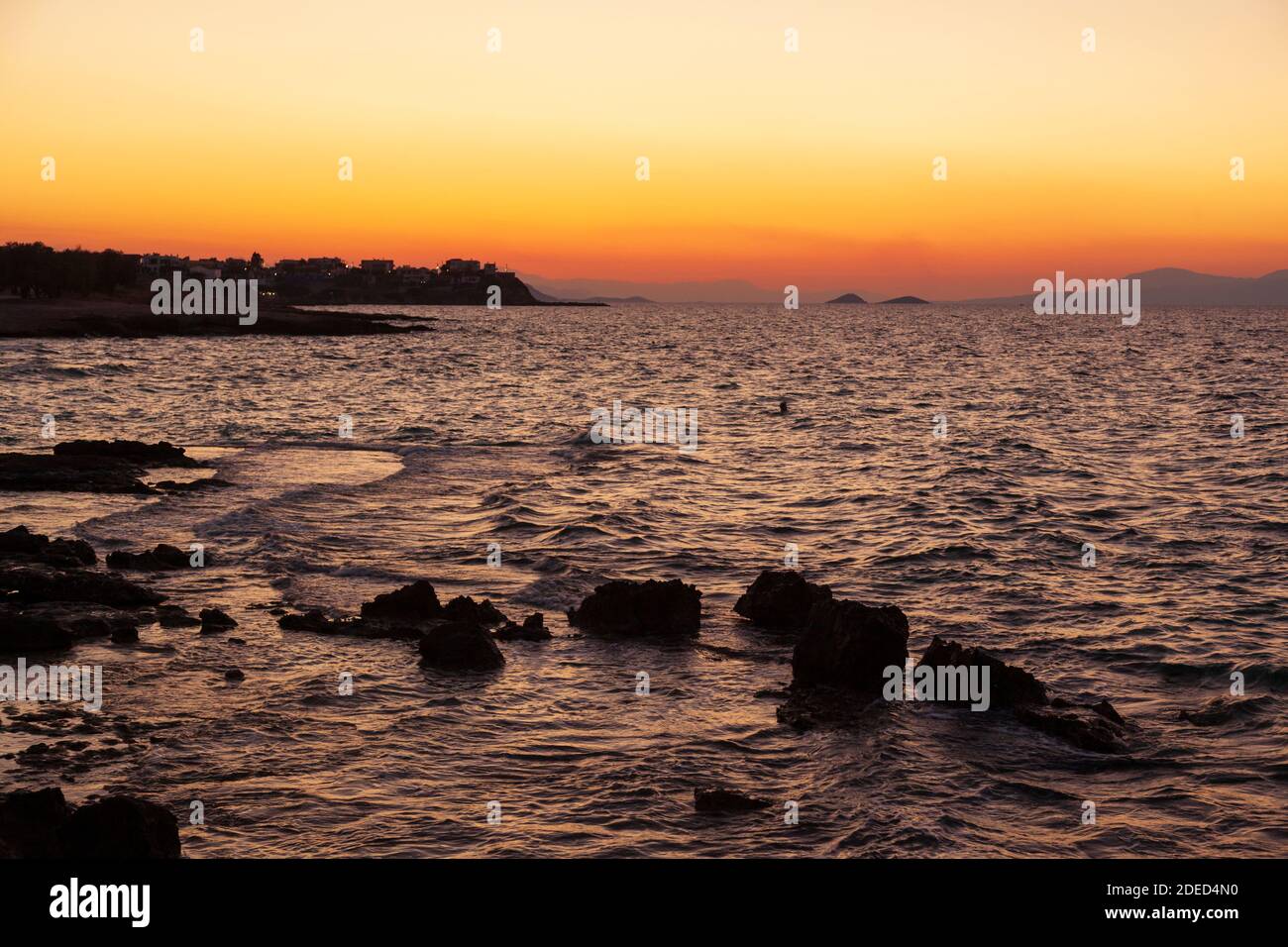 Sunset at a rocky beach near Souvala village, in Aegina island, Attica ...