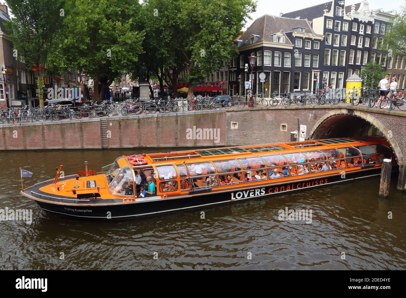AMSTERDAM, NETHERLANDS - JULY 10, 2017: People ride a sightseeing boat ...