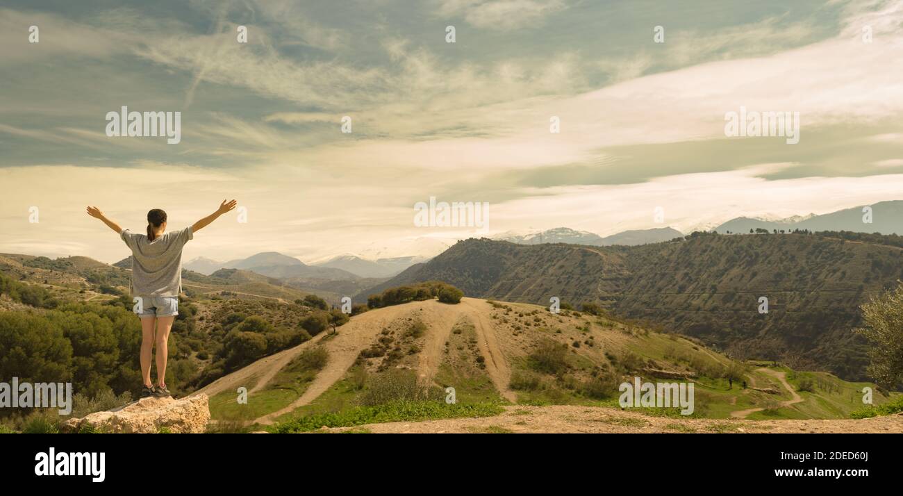 Young woman looking forward to reach the Sierra Nevada Mountain peak in ...