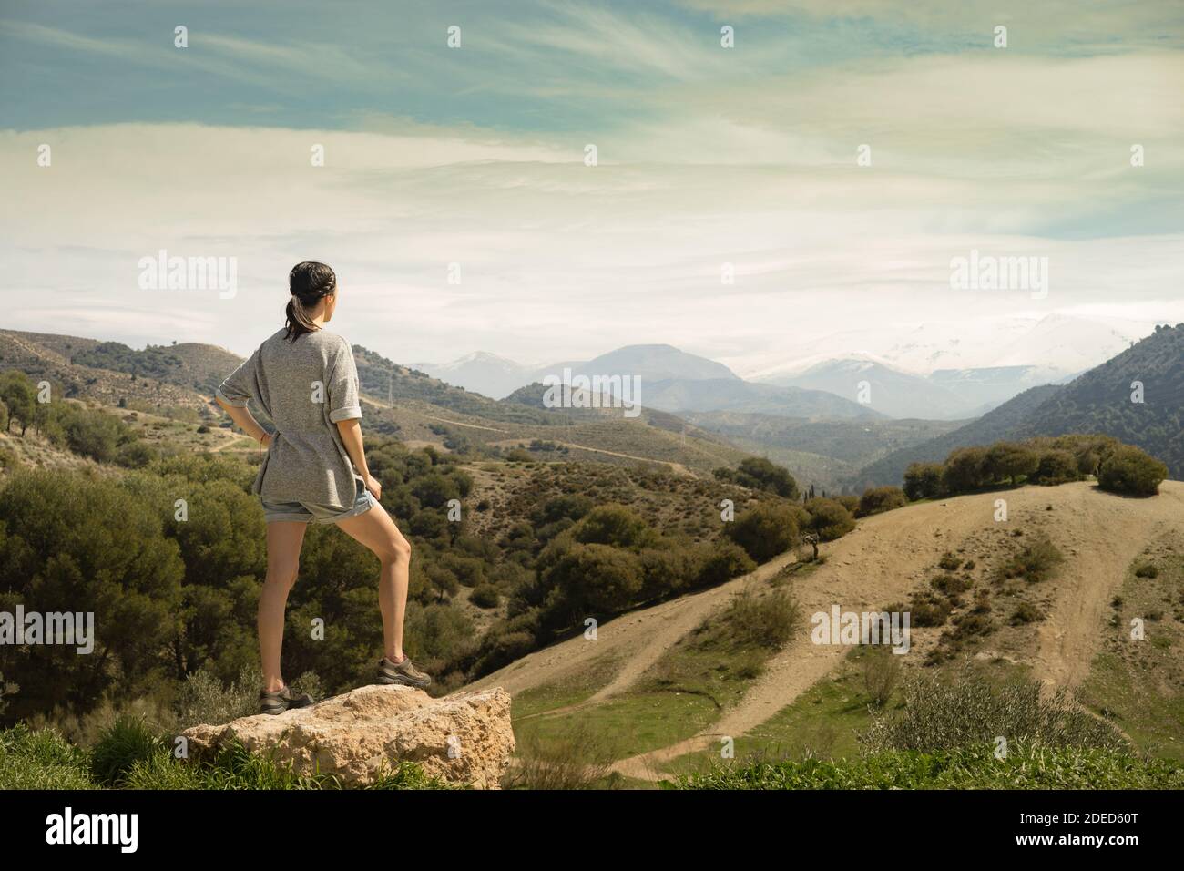 Young woman looking forward to reach the Sierra Nevada Mountain peak in ...