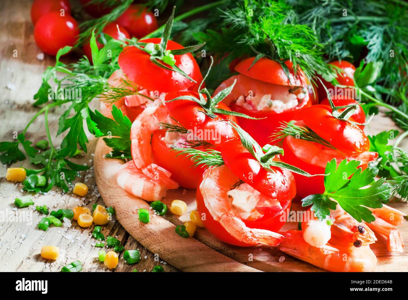 Fresh tomatoes stuffed with shrimp and corn, vintage wooden background ...