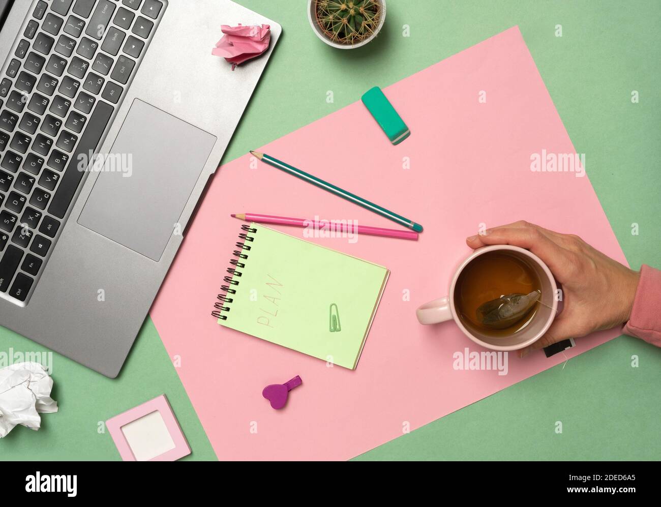 Top view of workplace photographer. Man typing on keyboard and drinking ...