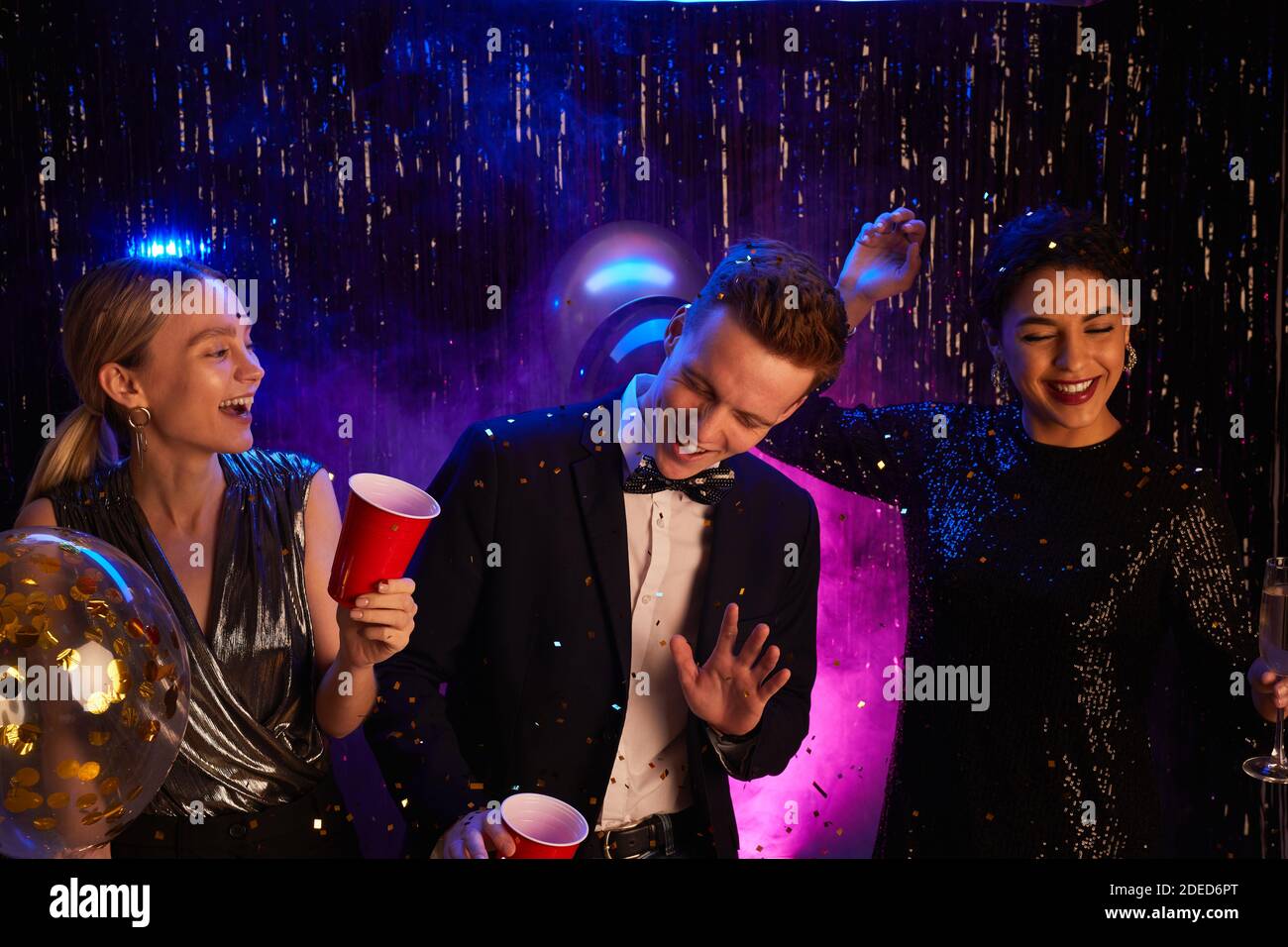 Portrait of three happy teenagers dancing and laughing while enjoying ...