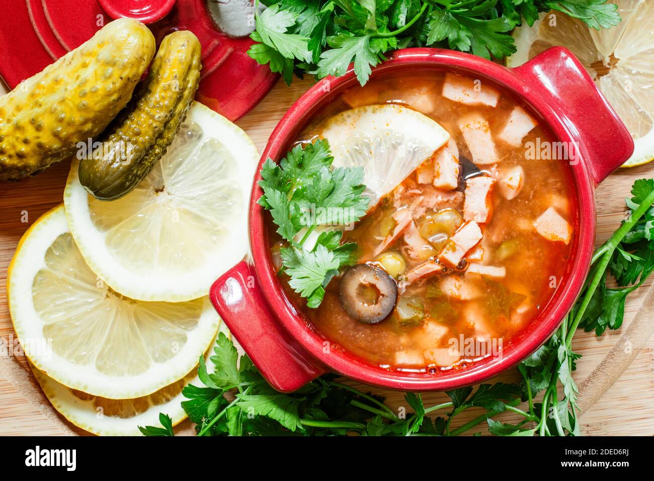 Russian Meat solyanka soup in ceramic portioned red pots, top view ...