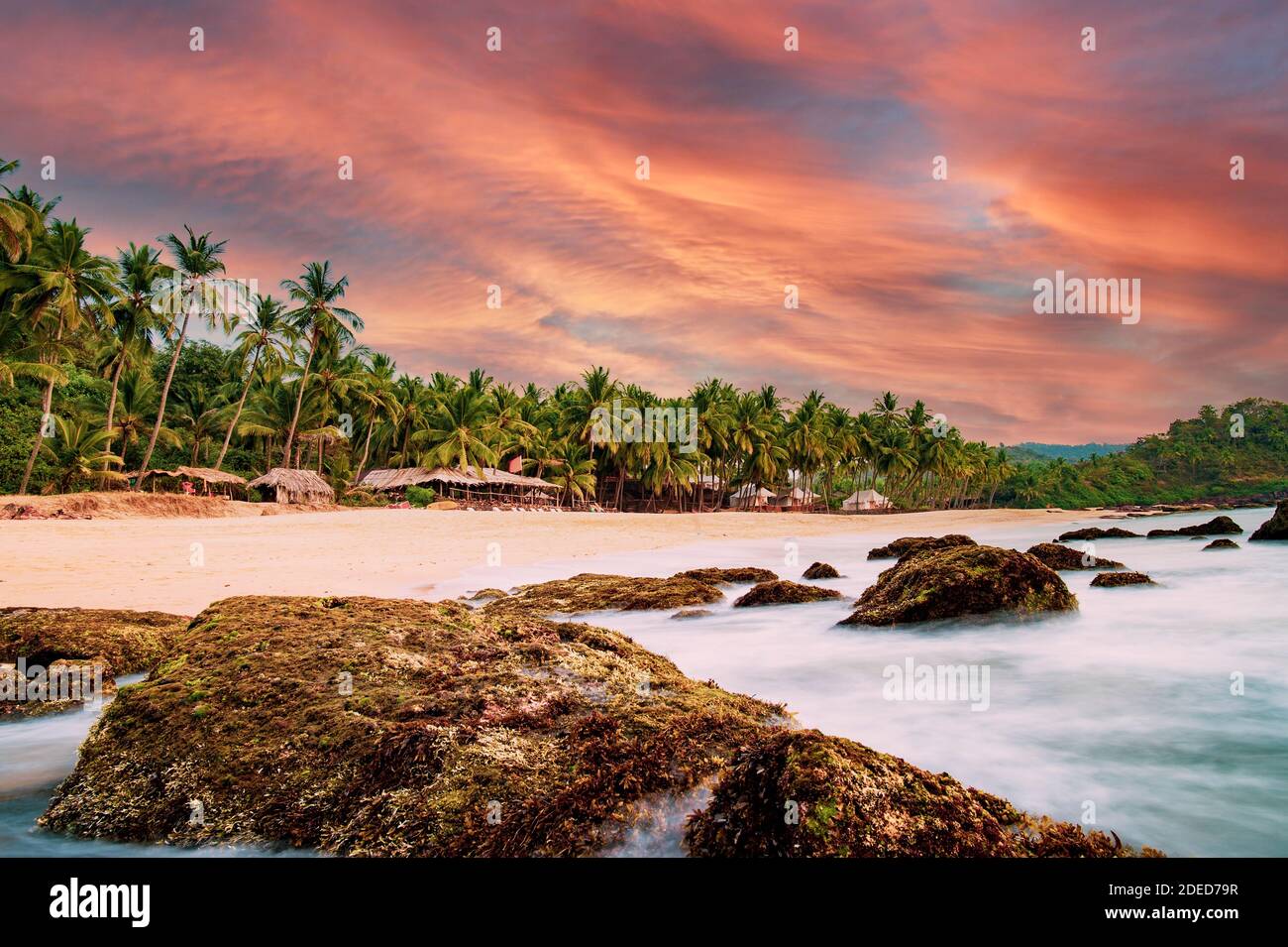 Long exposure. Beautiful and relaxing beach flanked by green palm trees ...