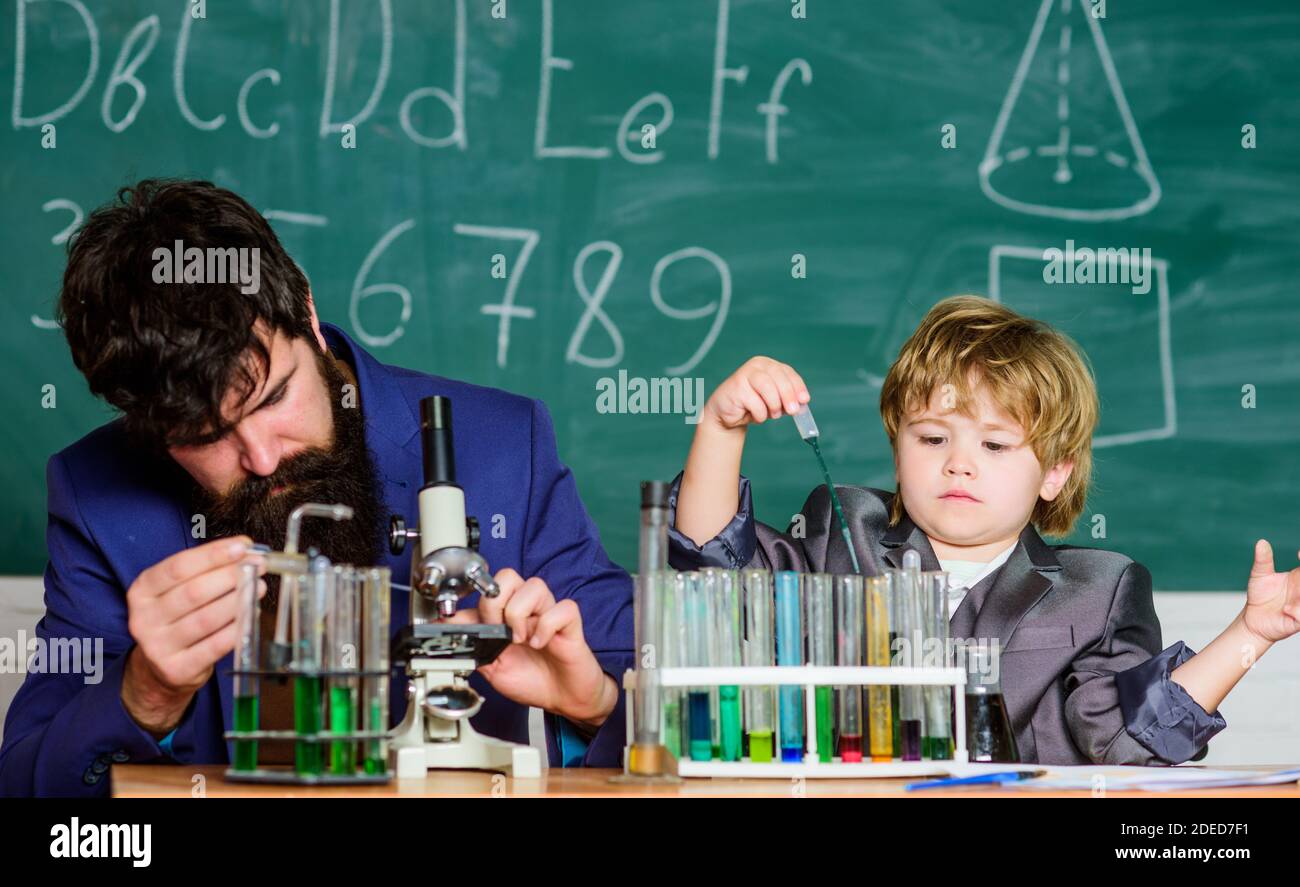 Science chemistry concept. bearded man teacher with little boy ...