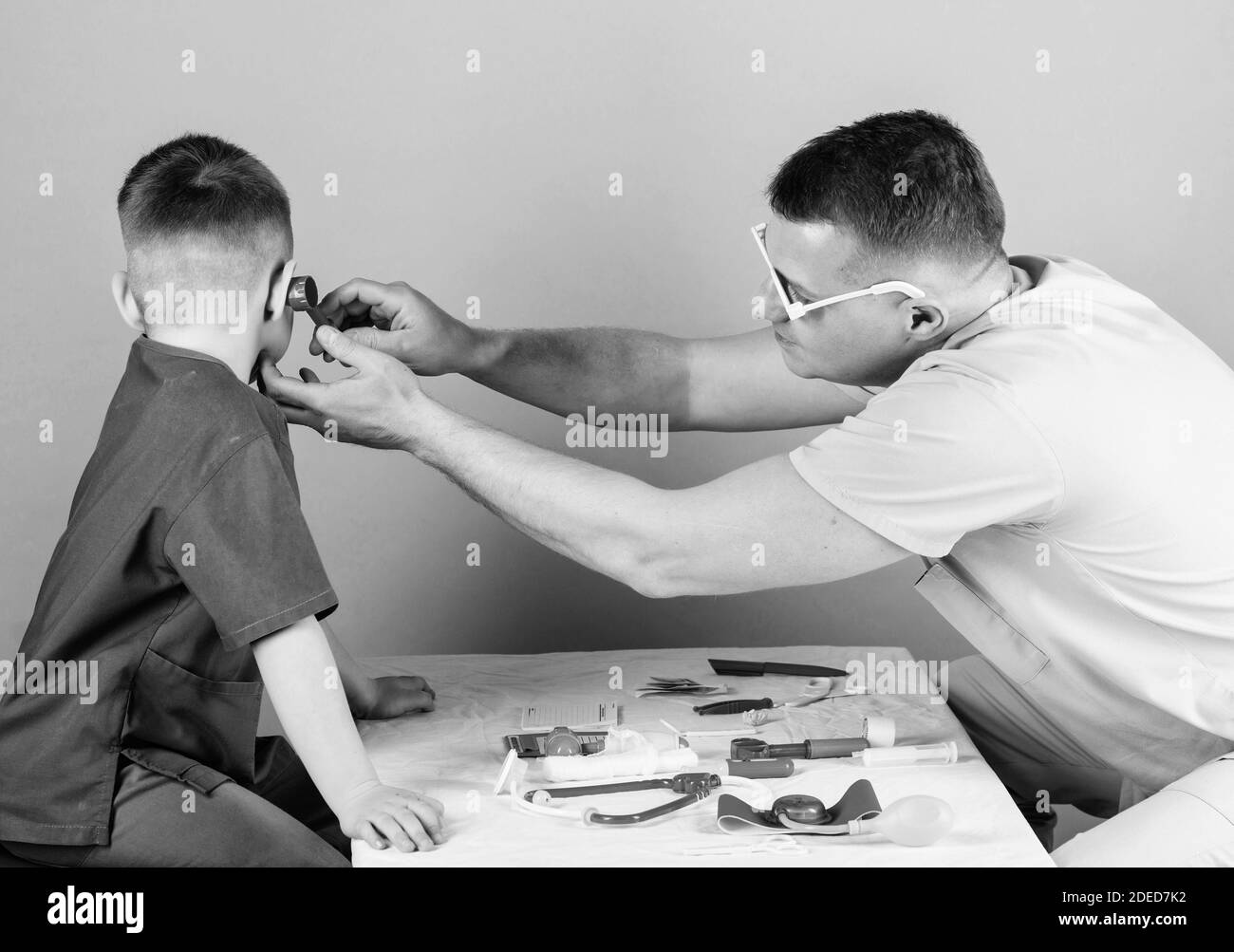 Hospital worker. Medical service. Man doctor sit table medical tools ...