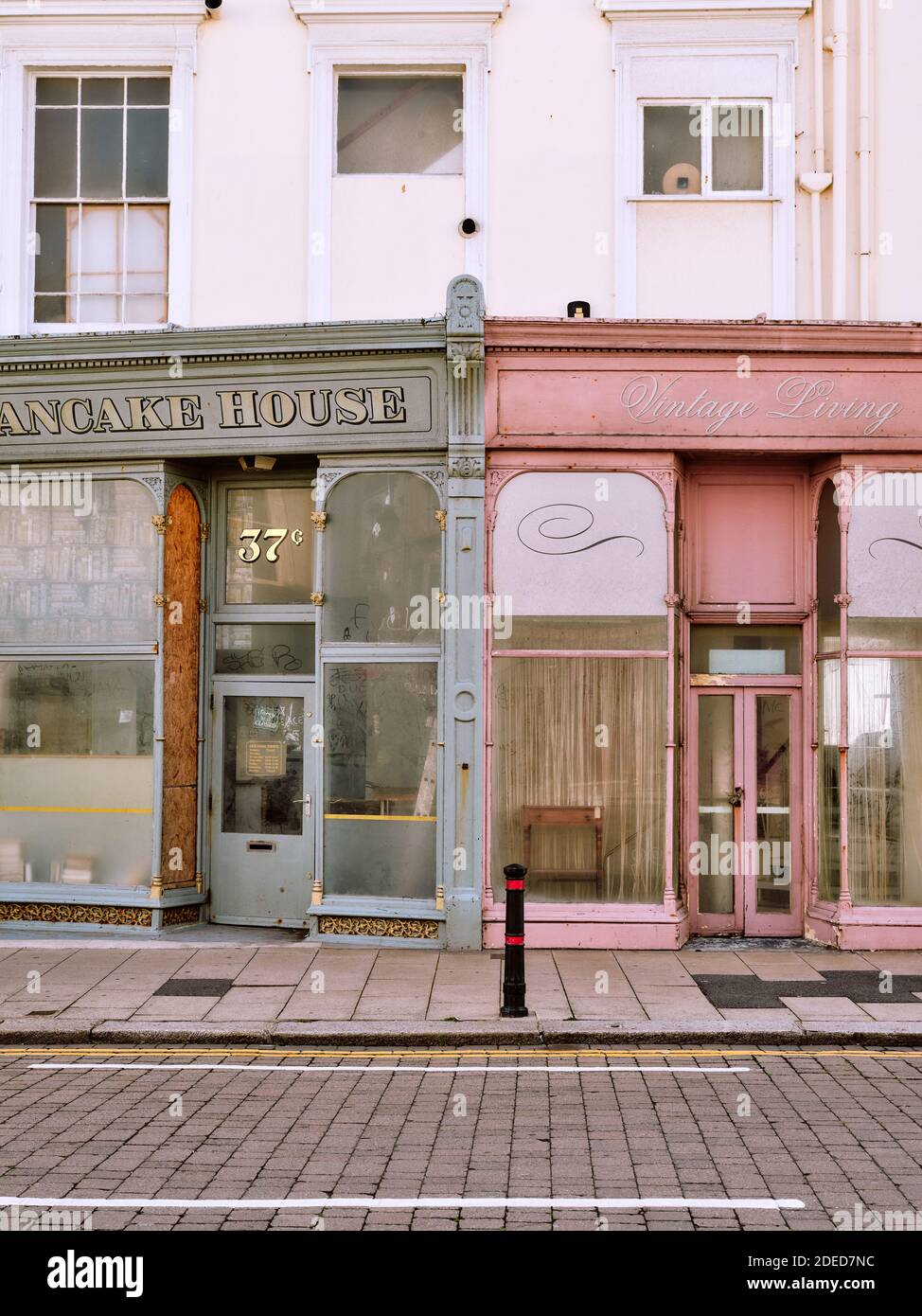 Empty closed old shopfronts on a street in Hastings Sussex England UK ...