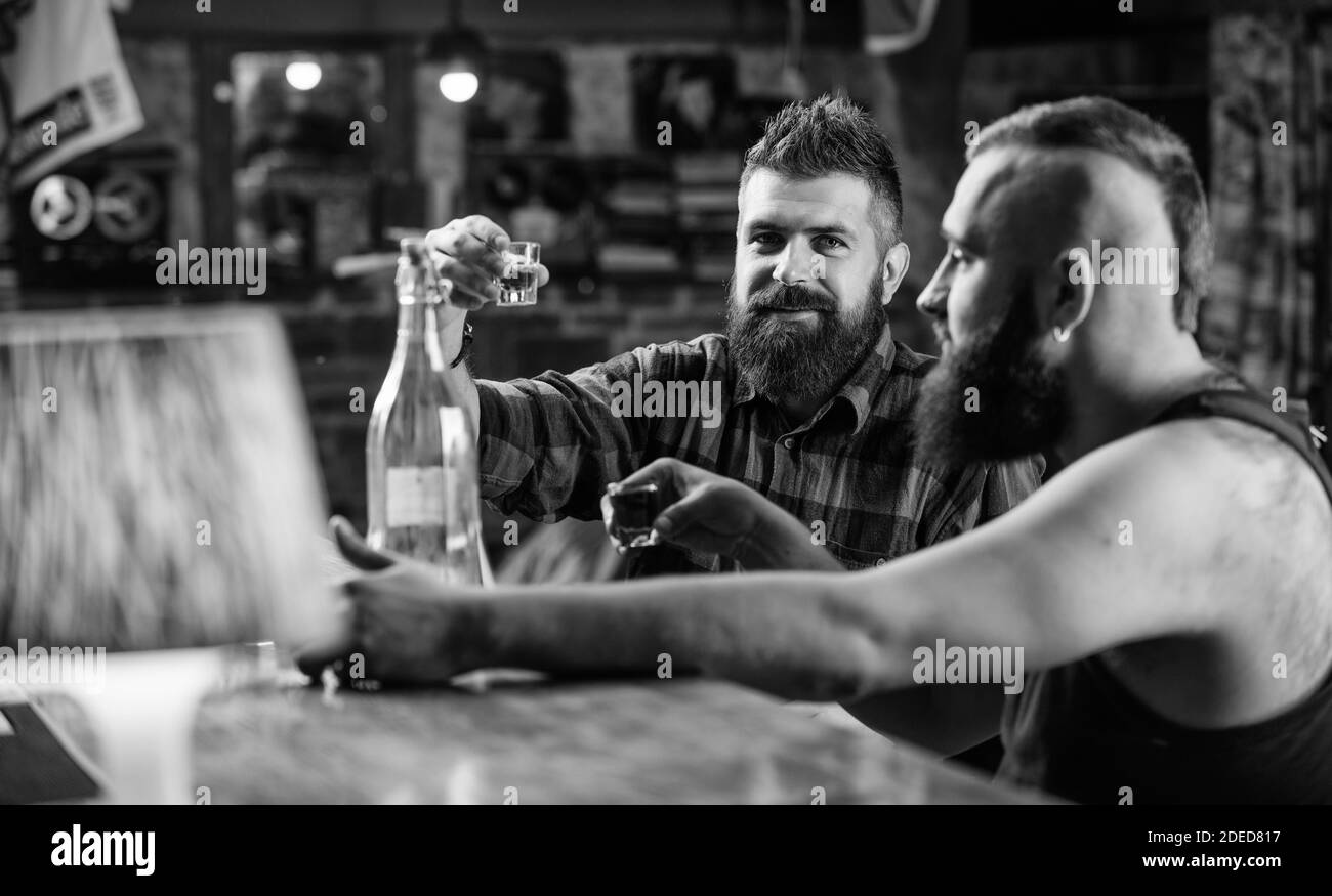 Men drinking alcohol together. Strong alcohol drinks. Friends relaxing ...