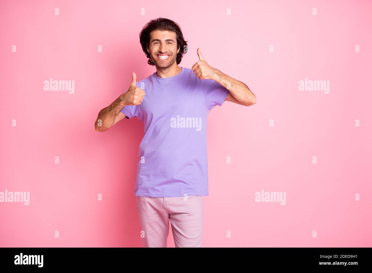 Portrait of person in good mood arms two thumbs up wear magenta ...