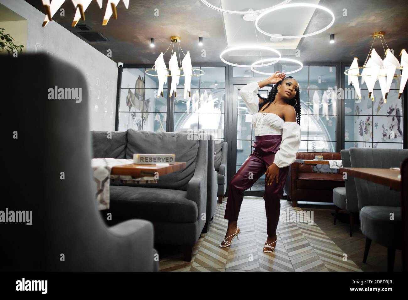 Beautiful african american woman in white blouse and red leather pants ...