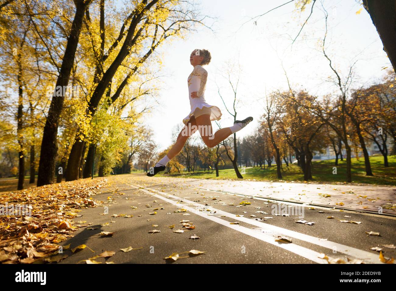 Ballerina dancing in nature park among autumn leaves Stock Photo - Alamy