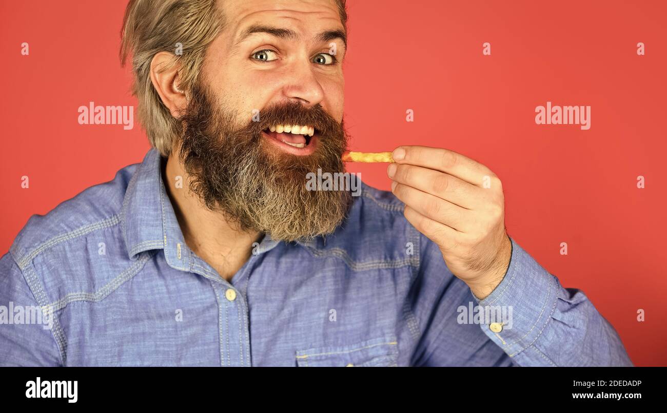 french fries at the street food market. bearded guy having snack. lazy ...