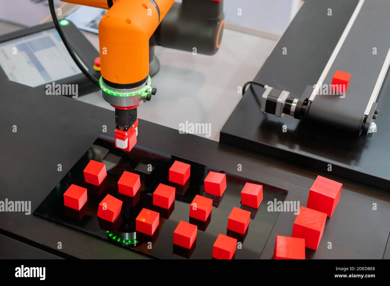 Pick and place robotic arm manipulator moving red toy blocks at robot exhibition Stock Photo - Alamy