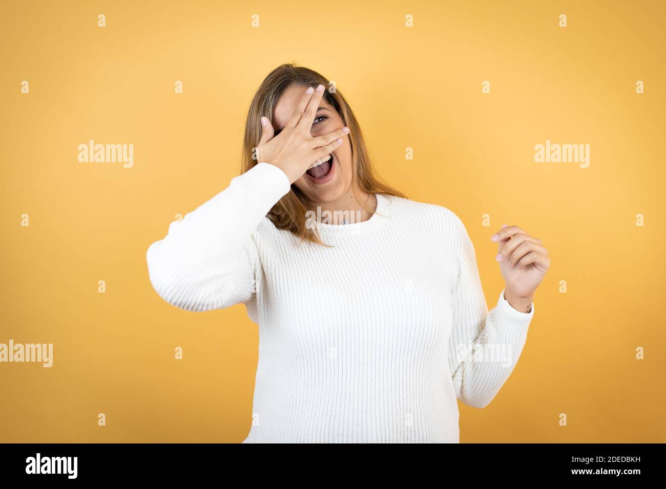 Hand over eyes peeking woman hi-res stock photography and images - Alamy
