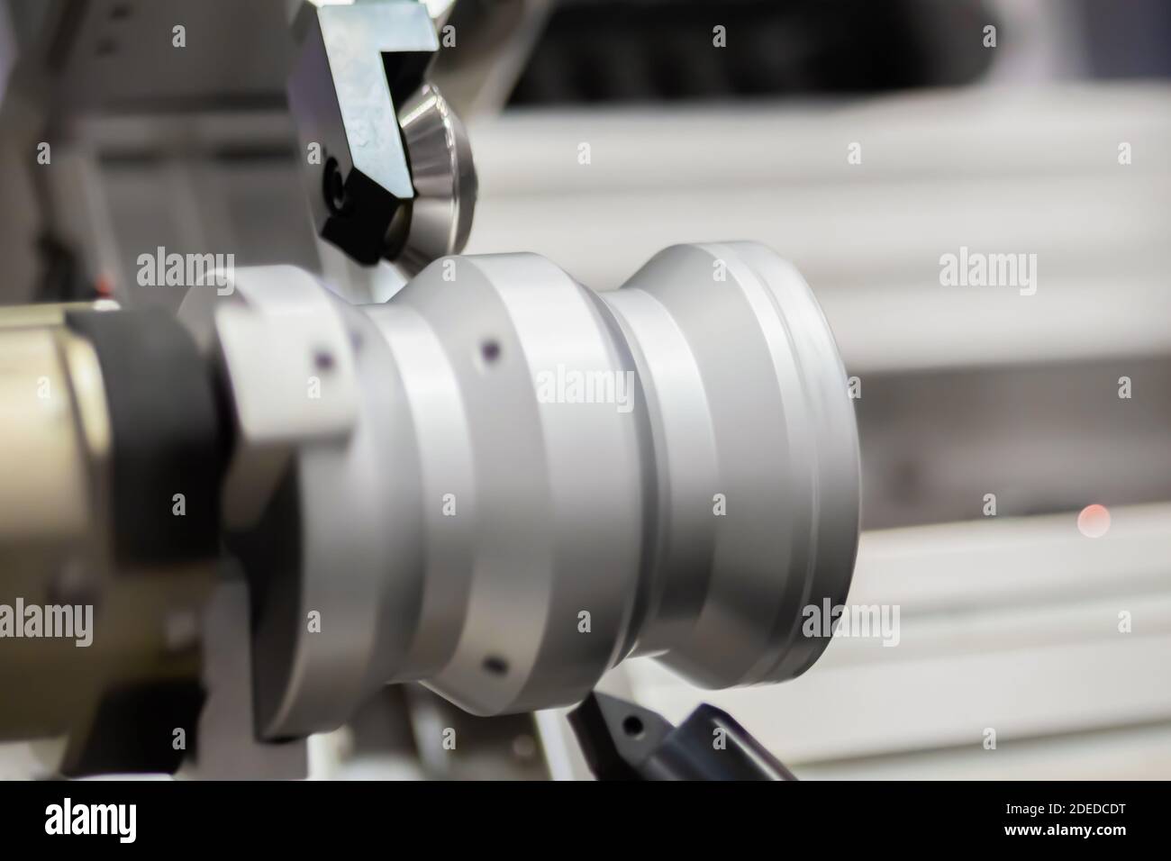 Automatic turning milling machine cutting metal workpiece at factory ...