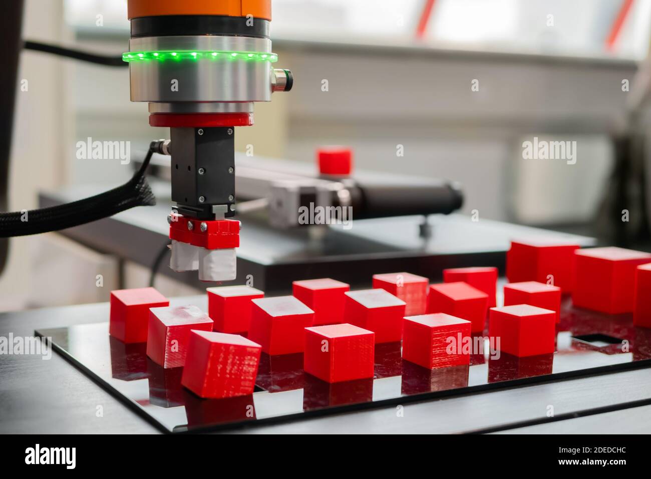 Pick and place robotic arm manipulator moving red toy blocks at robot exhibition Stock Photo - Alamy