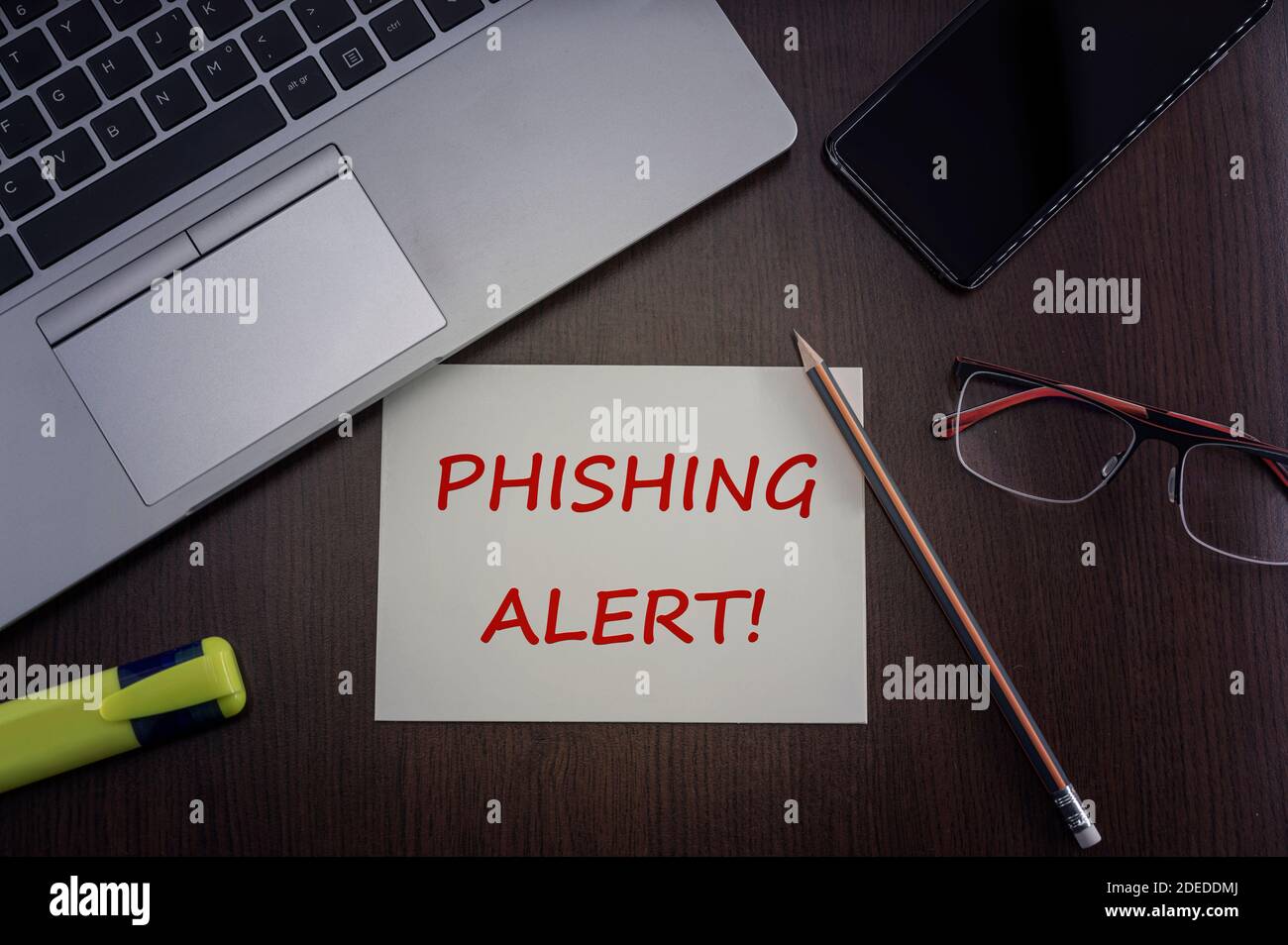 Phishing alert card. Top view of office table desktop background with ...
