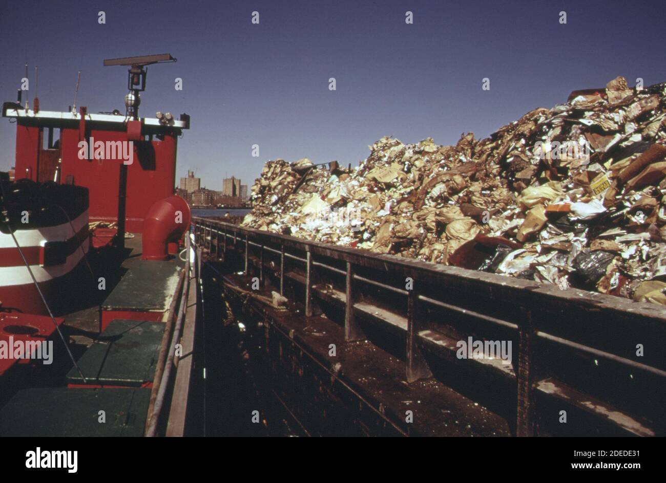 1970s Photo - (1973) - Tugboat tows heaped-up garbage scow from the ...