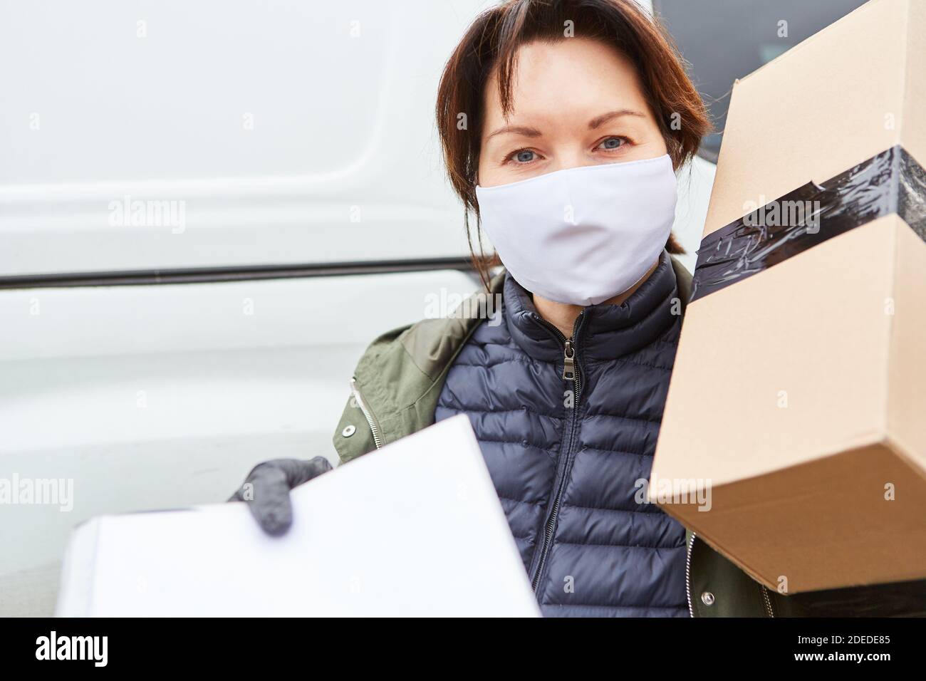 Delivery service parcel carrier with face mask holds list for ...