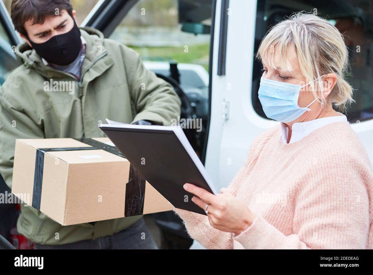 Parcel service checks checklist with parcel carriers with face masks ...