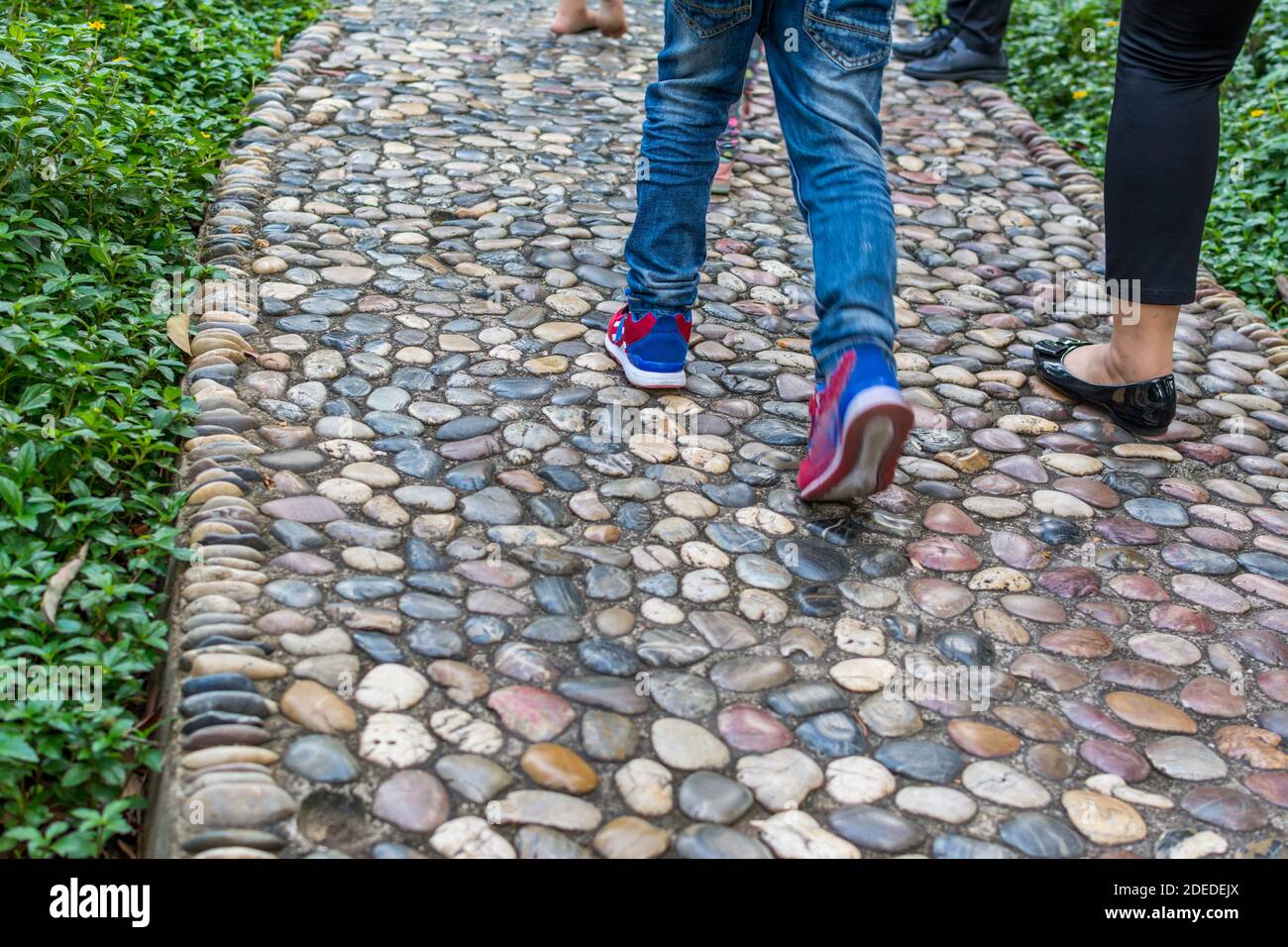 Woman walking cobble road hi-res stock photography and images - Alamy