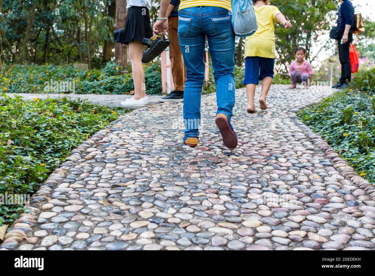Woman walking cobble road hi-res stock photography and images - Alamy