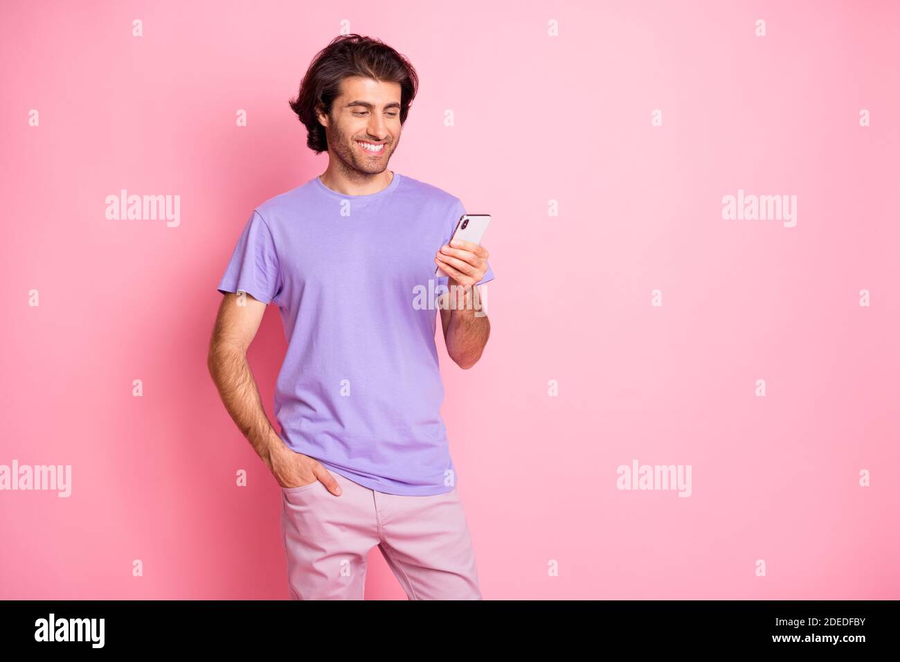 Portrait of nice blogger look phone arm in pocket check social network ...