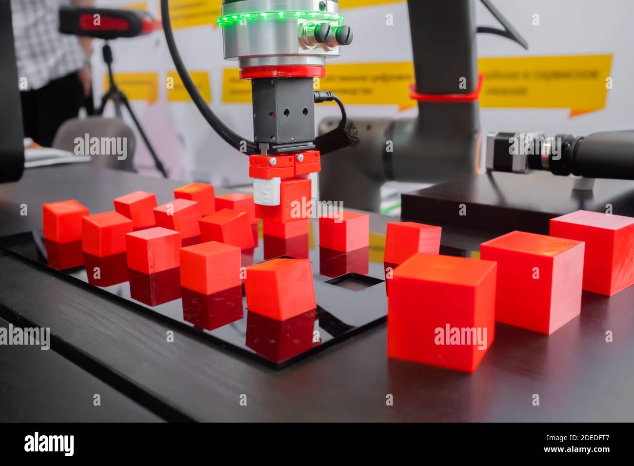Pick and place robotic arm manipulator moving red toy blocks at robot exhibition Stock Photo - Alamy