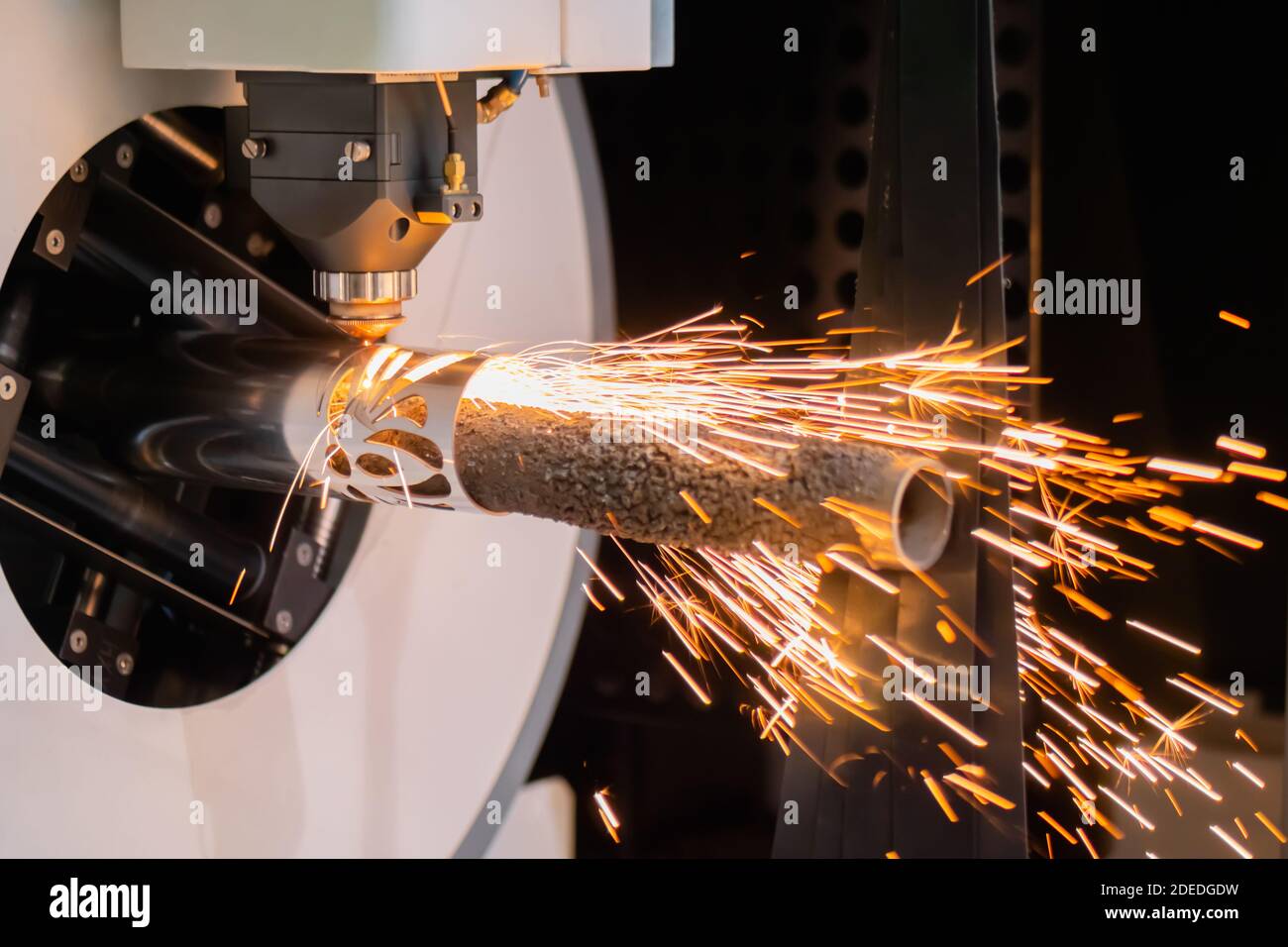 Laser cutting machine working with cylindrical metal workpiece with ...