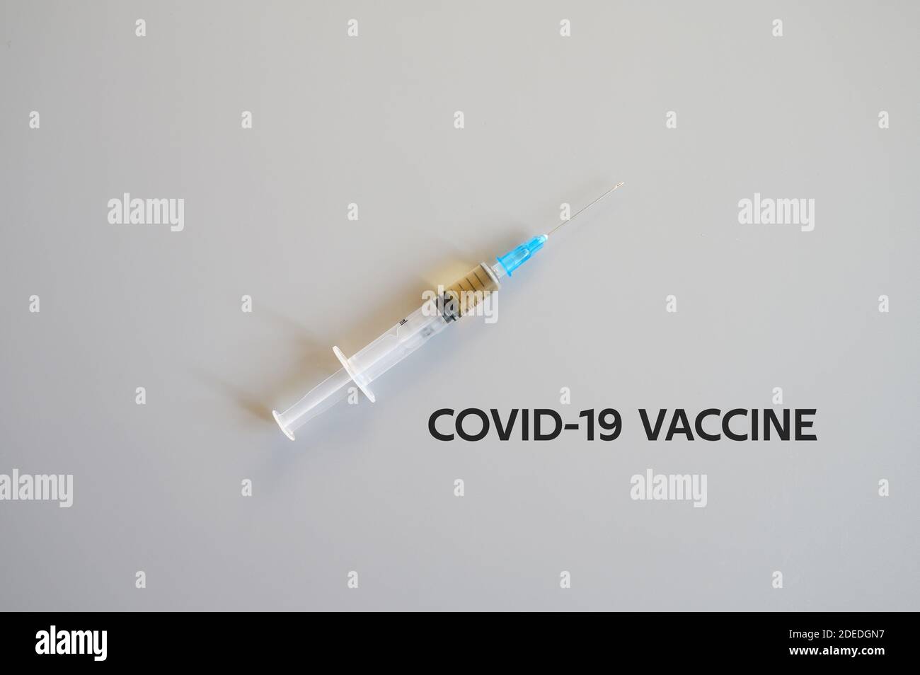 syringe with injection vaccine on a gray background. medicine plastic ...
