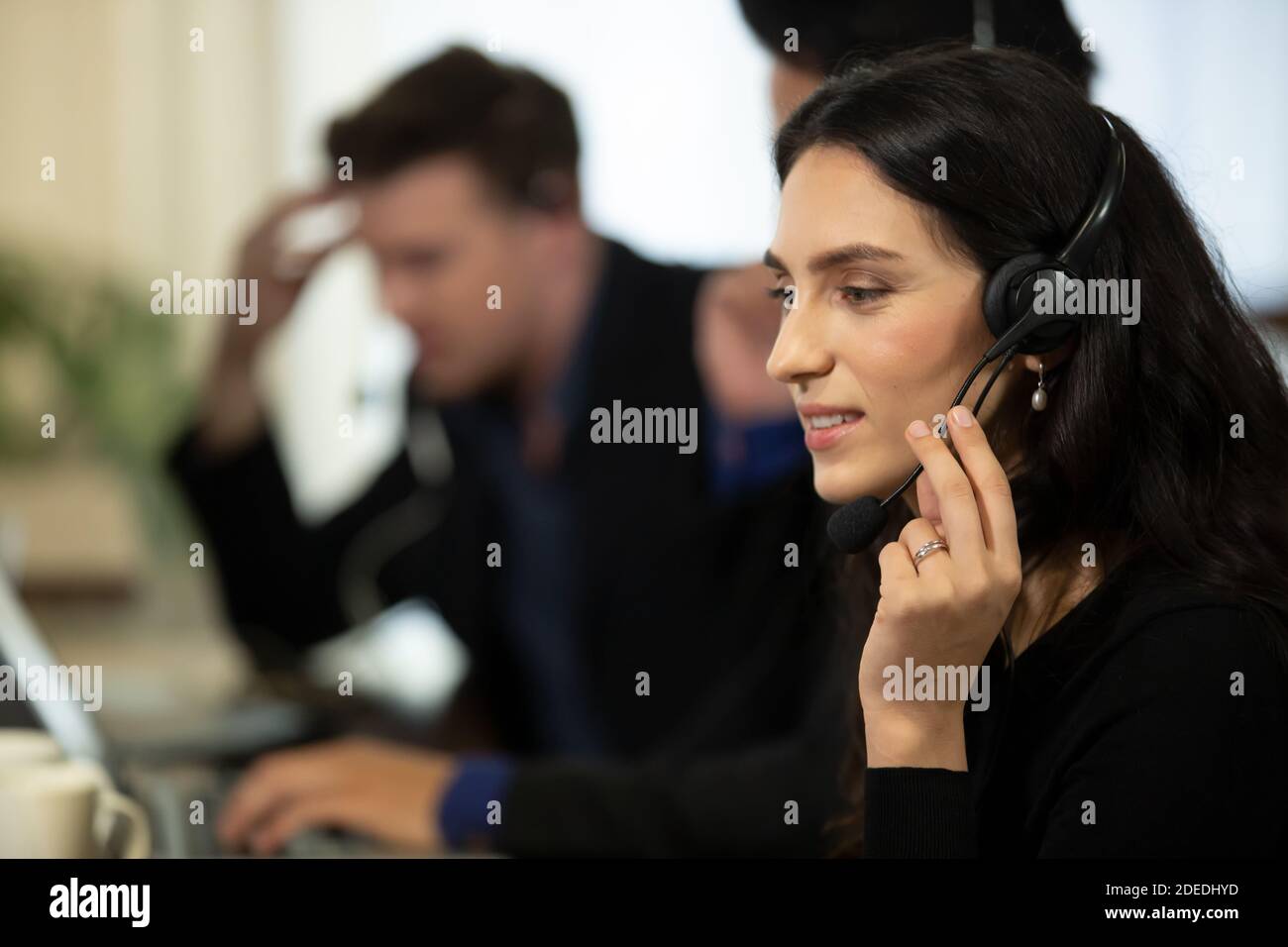 side view.the call center operator and her colleagues work in the ...