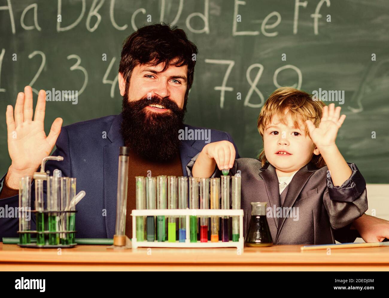 Living innovation. teacher man with little boy. Laboratory test tubes ...