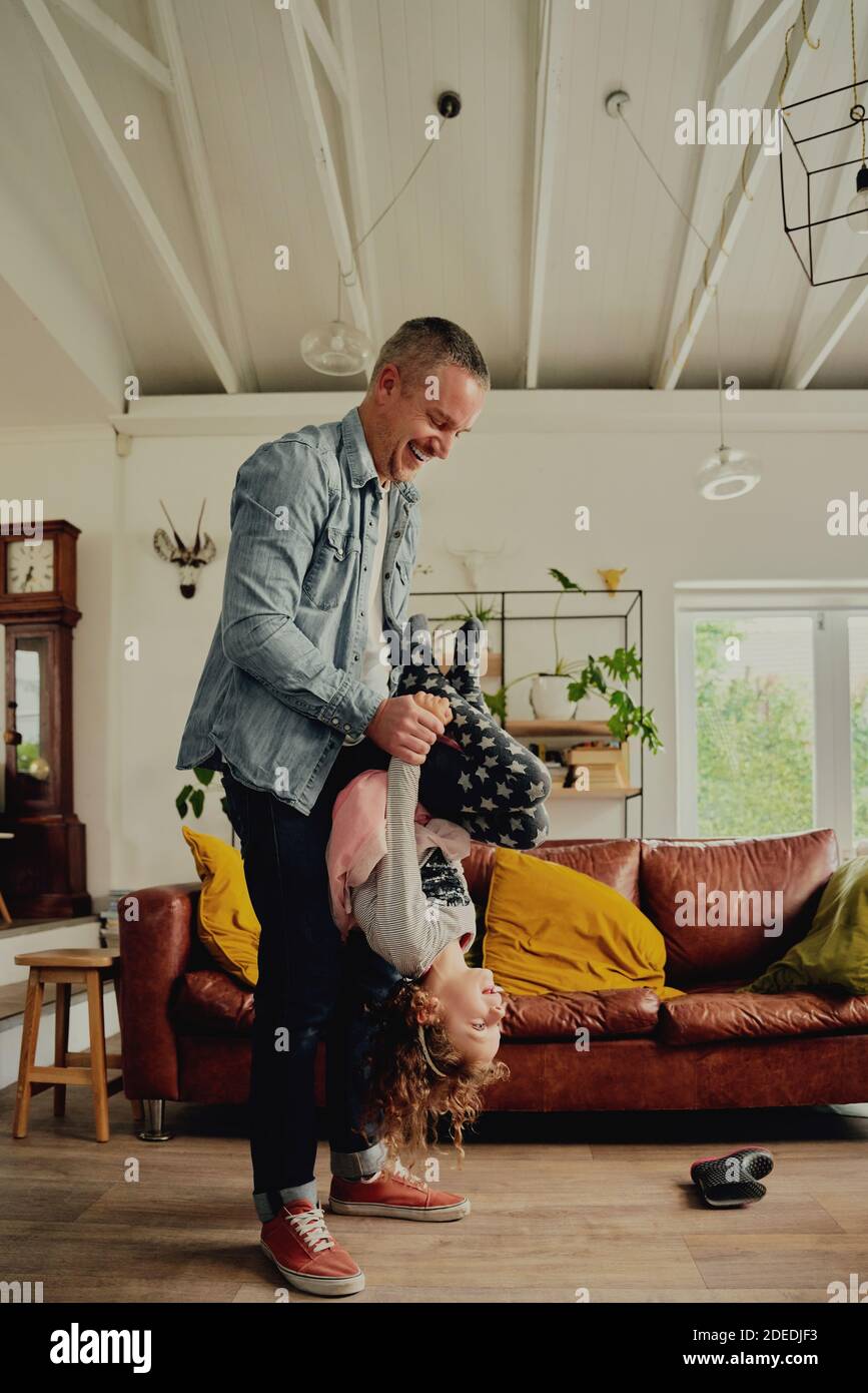 Father holding child upside down hi-res stock photography and images - Alamy