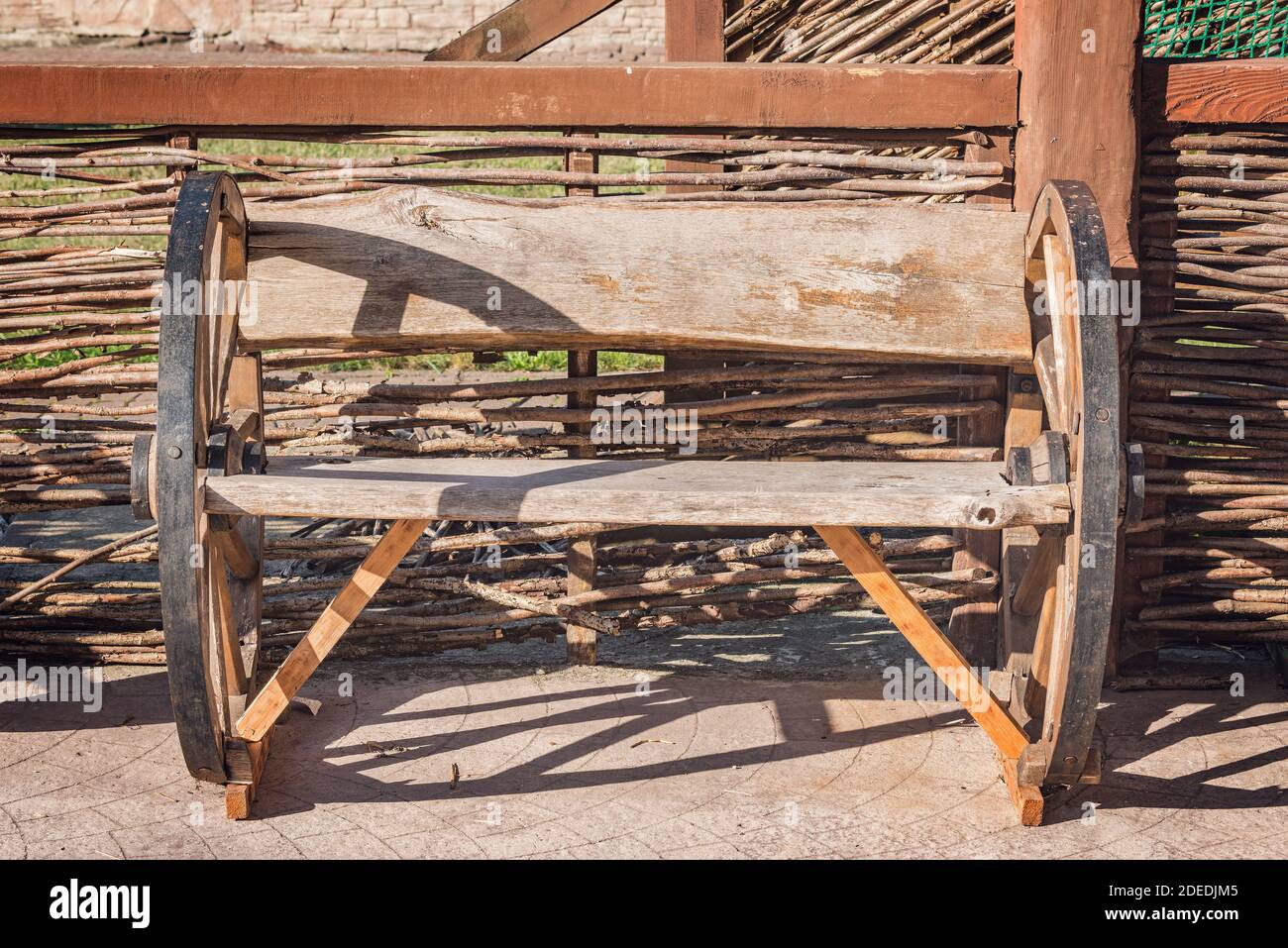 Wooden retro bench by the wooden fence Stock Photo - Alamy