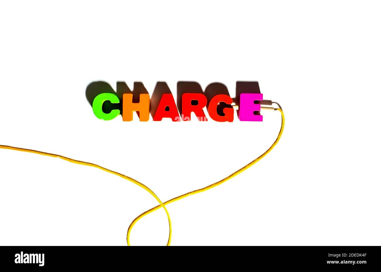 Word text Charge by wooden colorful letters inscription, strung on a ...