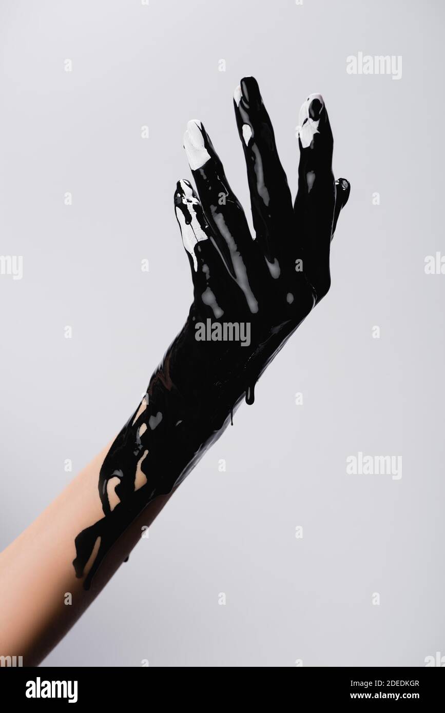 cropped view of hand with dripping black paint isolated on white Stock ...
