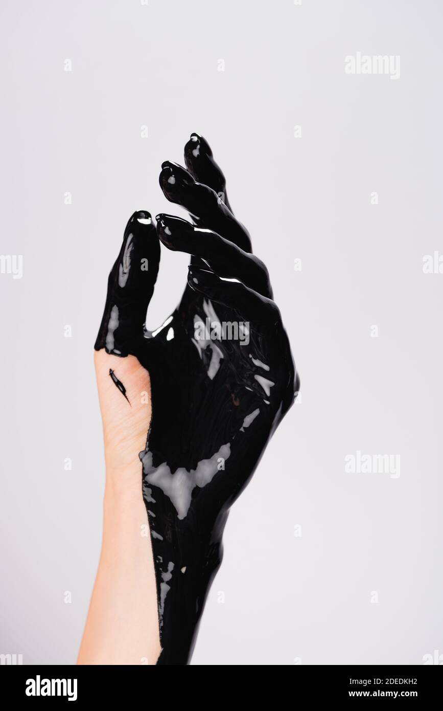 cropped view of hand with dripping black paint isolated on white Stock ...