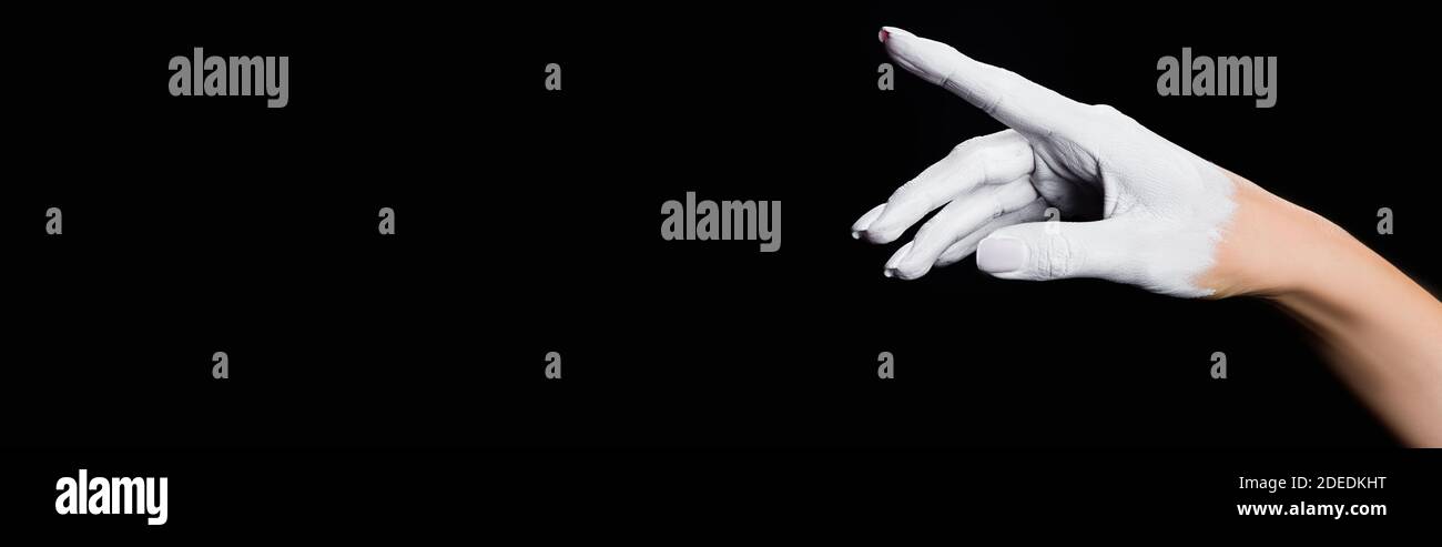 partial view of white painted hand isolated on black, banner Stock ...