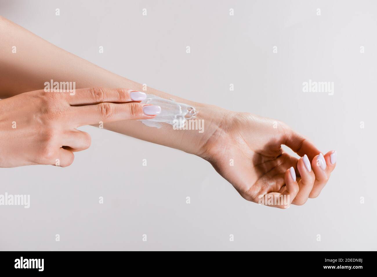 Woman applying lotion arm hi-res stock photography and images - Alamy