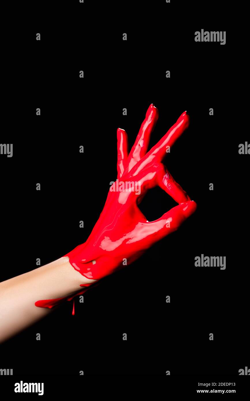 cropped view of hand painted in red paint showing ok sign isolated on ...