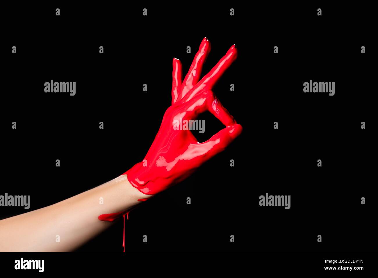 cropped view of hand painted in red paint showing ok sign isolated on ...