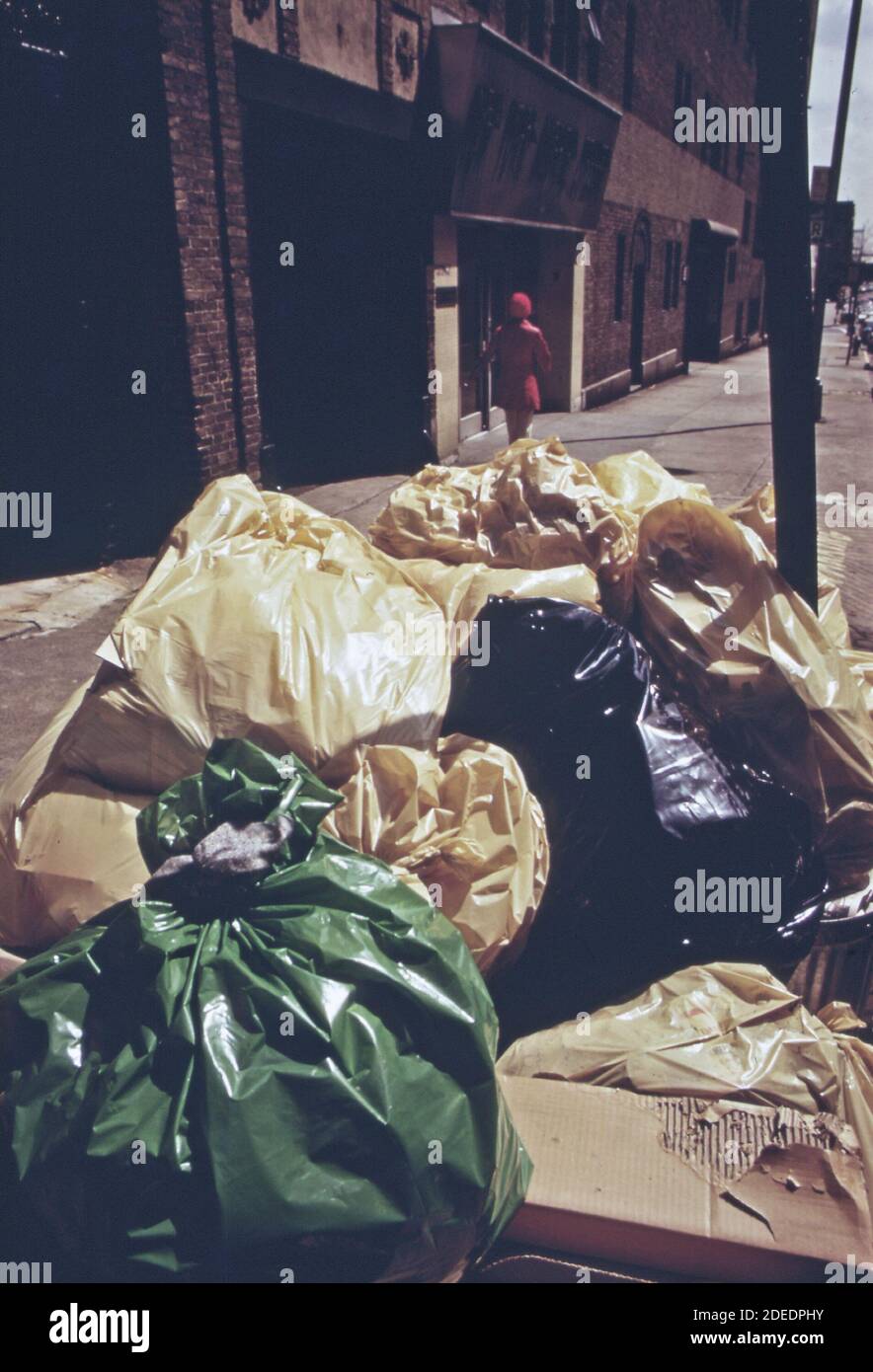 1970s Photo - (1973) - Garbage is piled high on the sidewalk outside ...