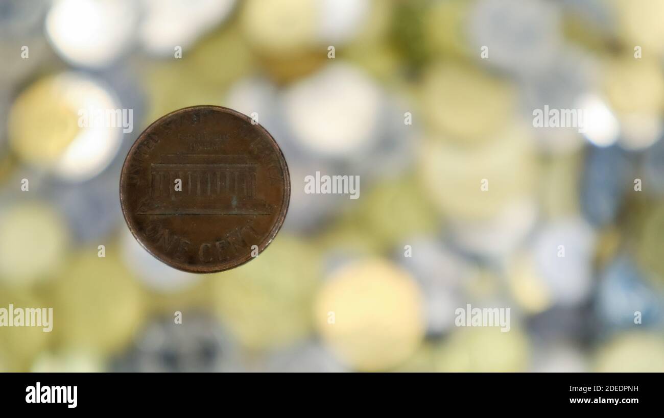 One 1 cent coin is shown in close-up. This is money. Blurred money ...