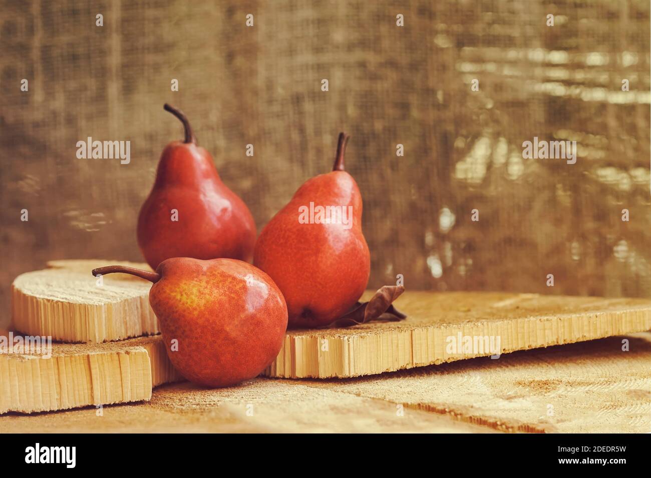 Fresh ripe organic red pears on wooden saw cut, vintage rustic ...