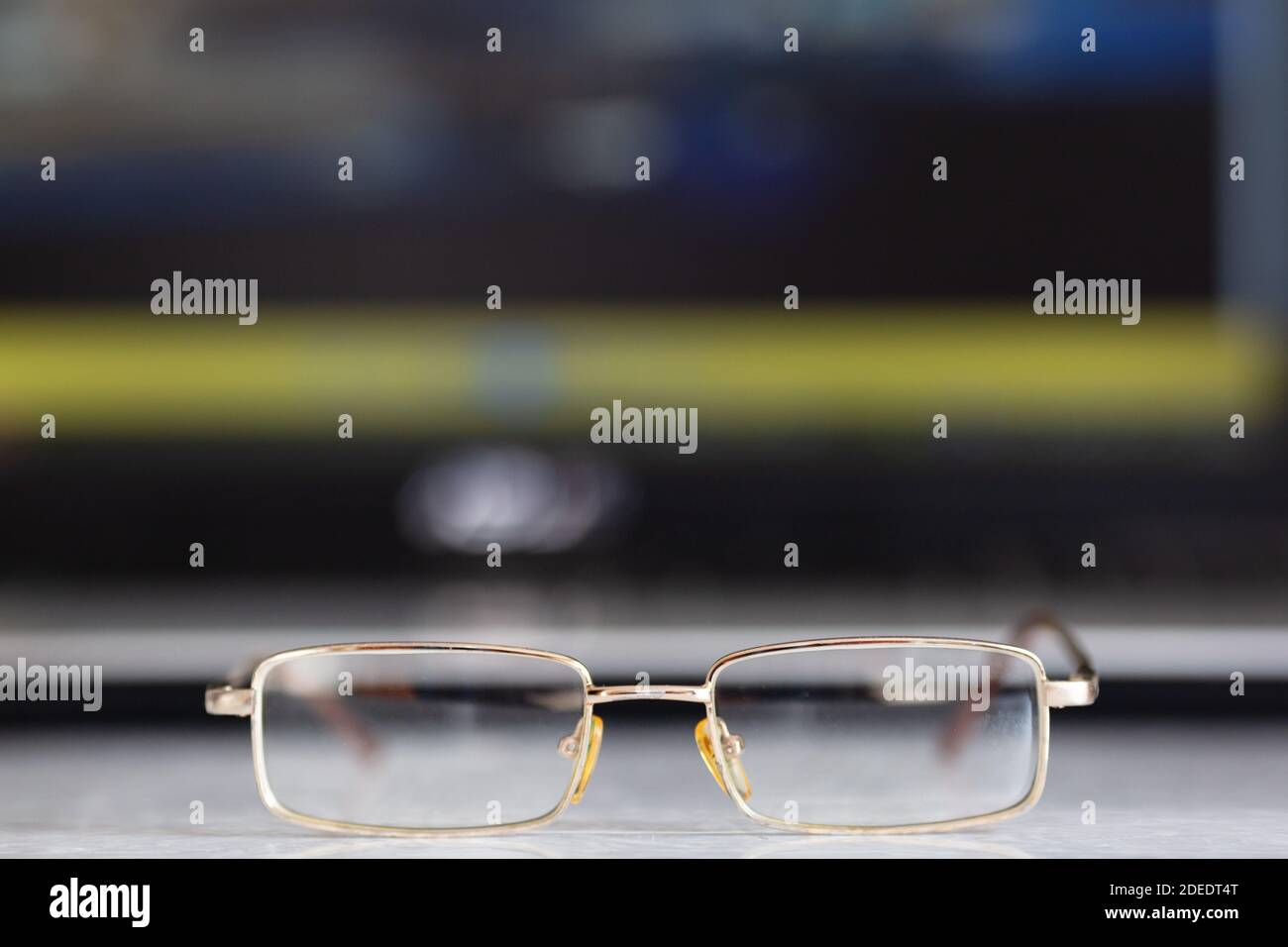 Gold rimmed eyeglasses for office workplace., Close-up Stock Photo - Alamy